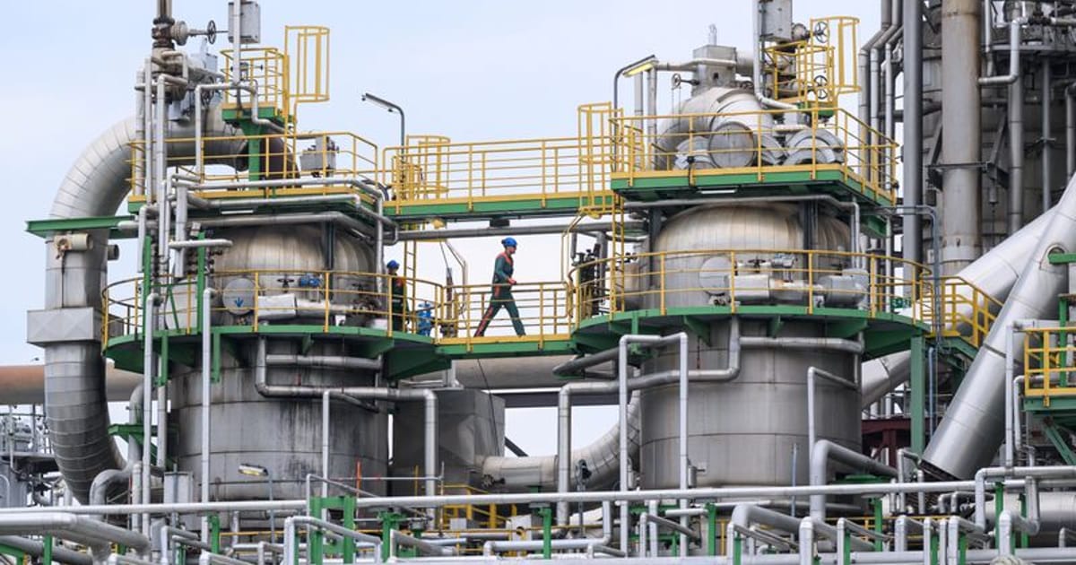 German Industry Job Cuts Persist Despite Sales Growth Says EY